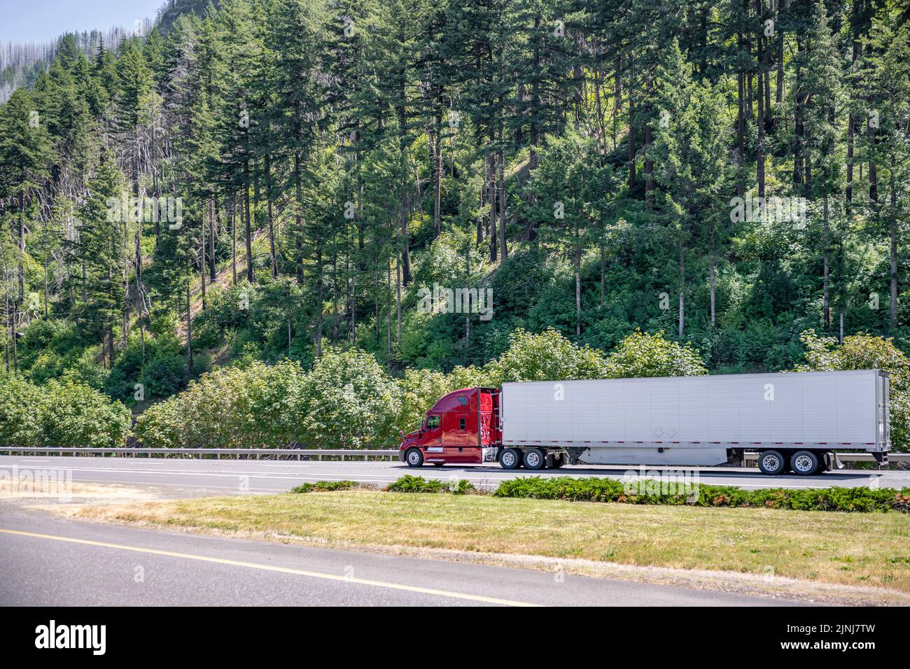 Dark red industrial big rig semi truck with high roof cab transporting ...