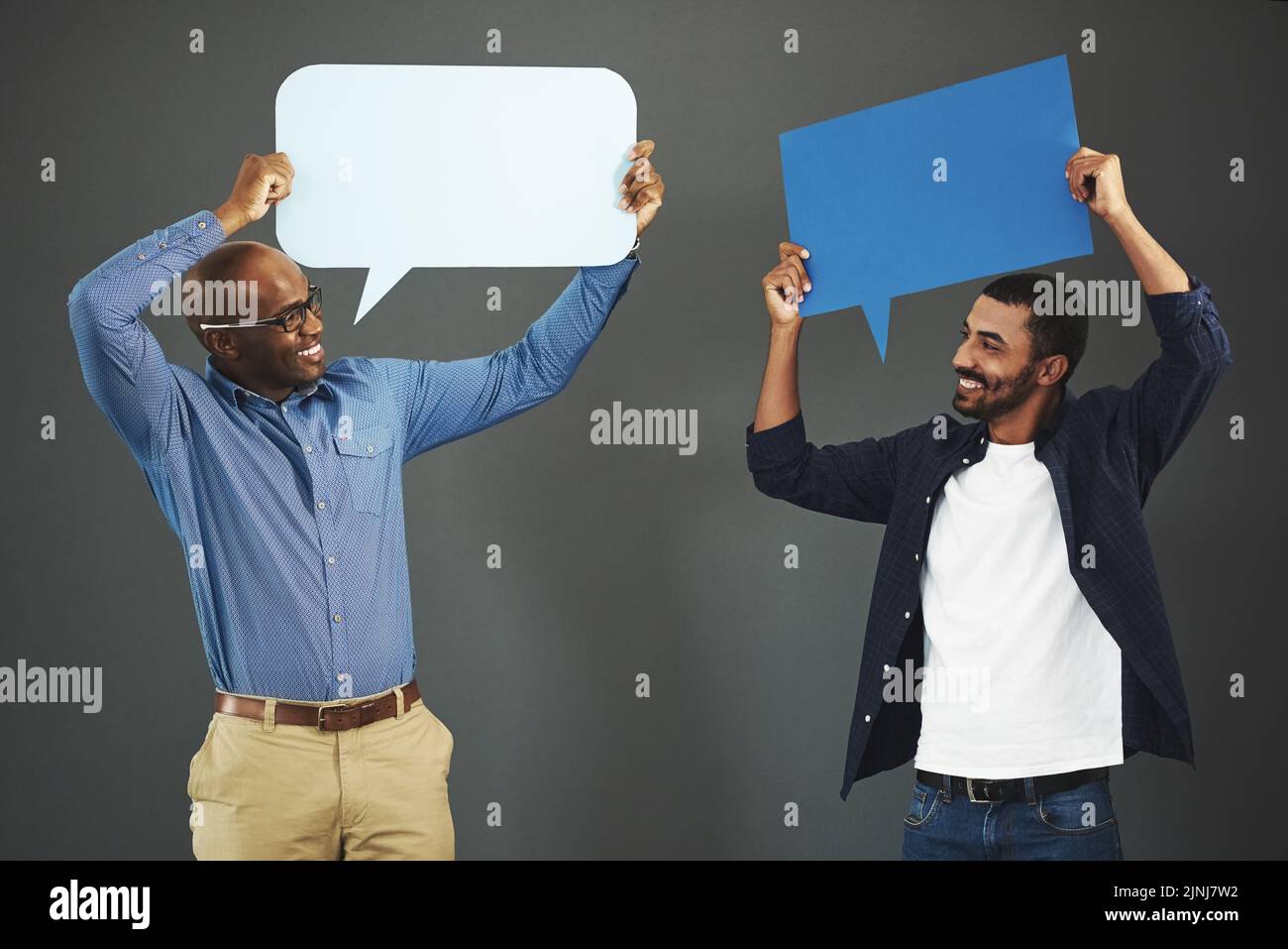 Men holding speech bubbles for social media communication via messaging ...