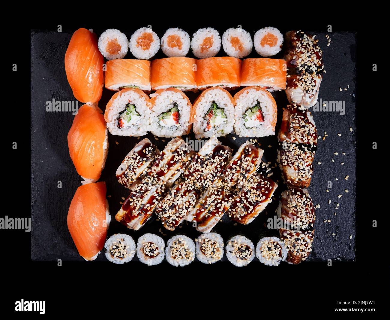 Japanese oriental cuisine. Top view of a large set of sushi on a black ...
