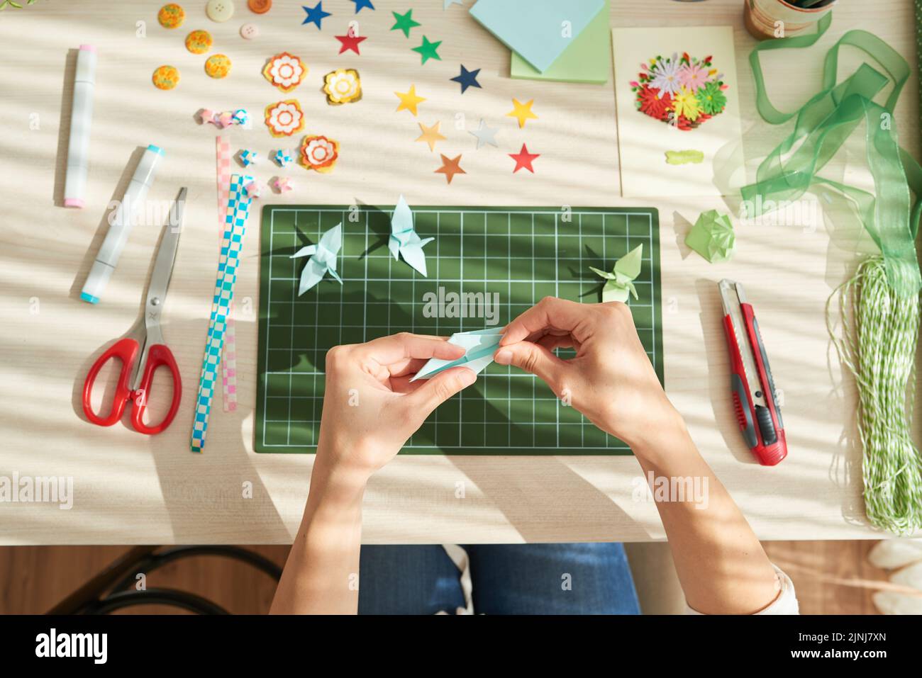 Woman making origami cranes hi-res stock photography and images - Alamy
