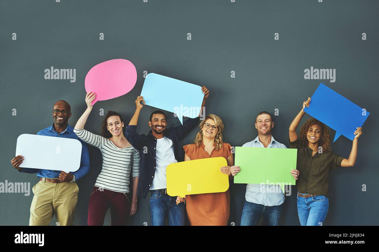 Smiling casual team of diverse people holding opinion speech bubbles ...