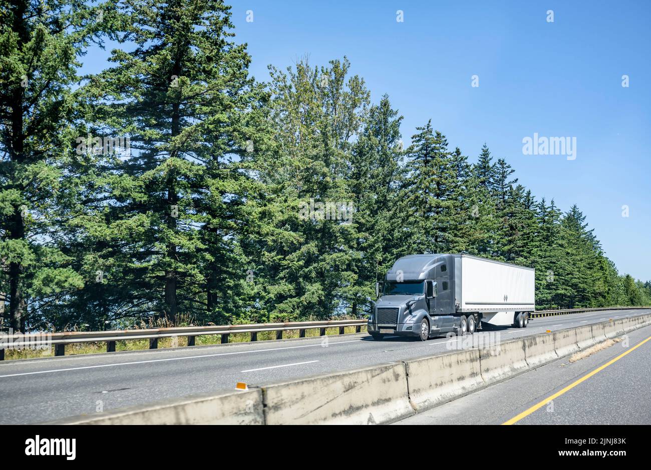 Gray industrial big rig semi truck with truck driver cab sleep ...