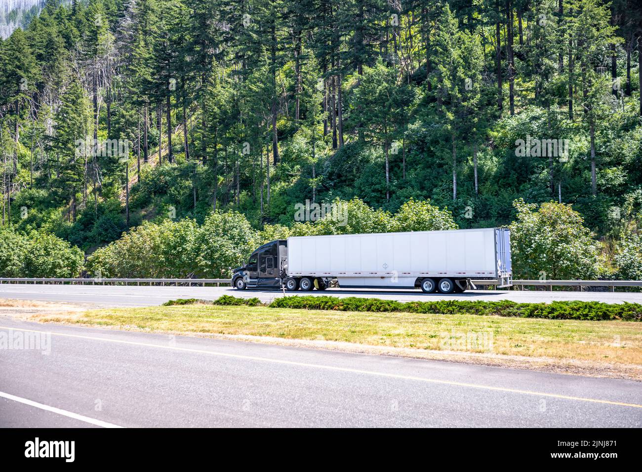 Black industrial big rig semi truck with truck driver cab sleep ...
