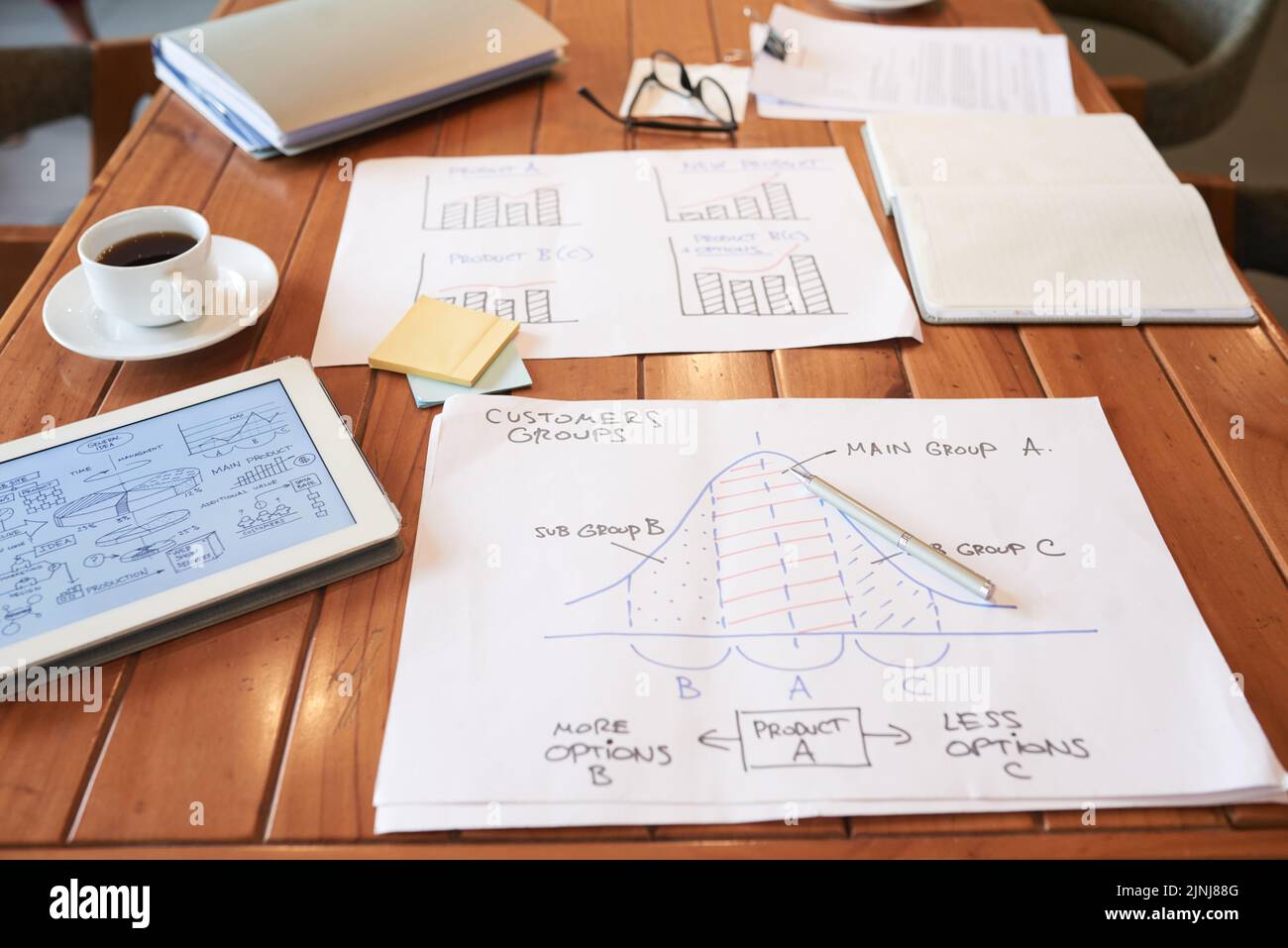 Working process at modern boardroom: surface of wooden table covered ...