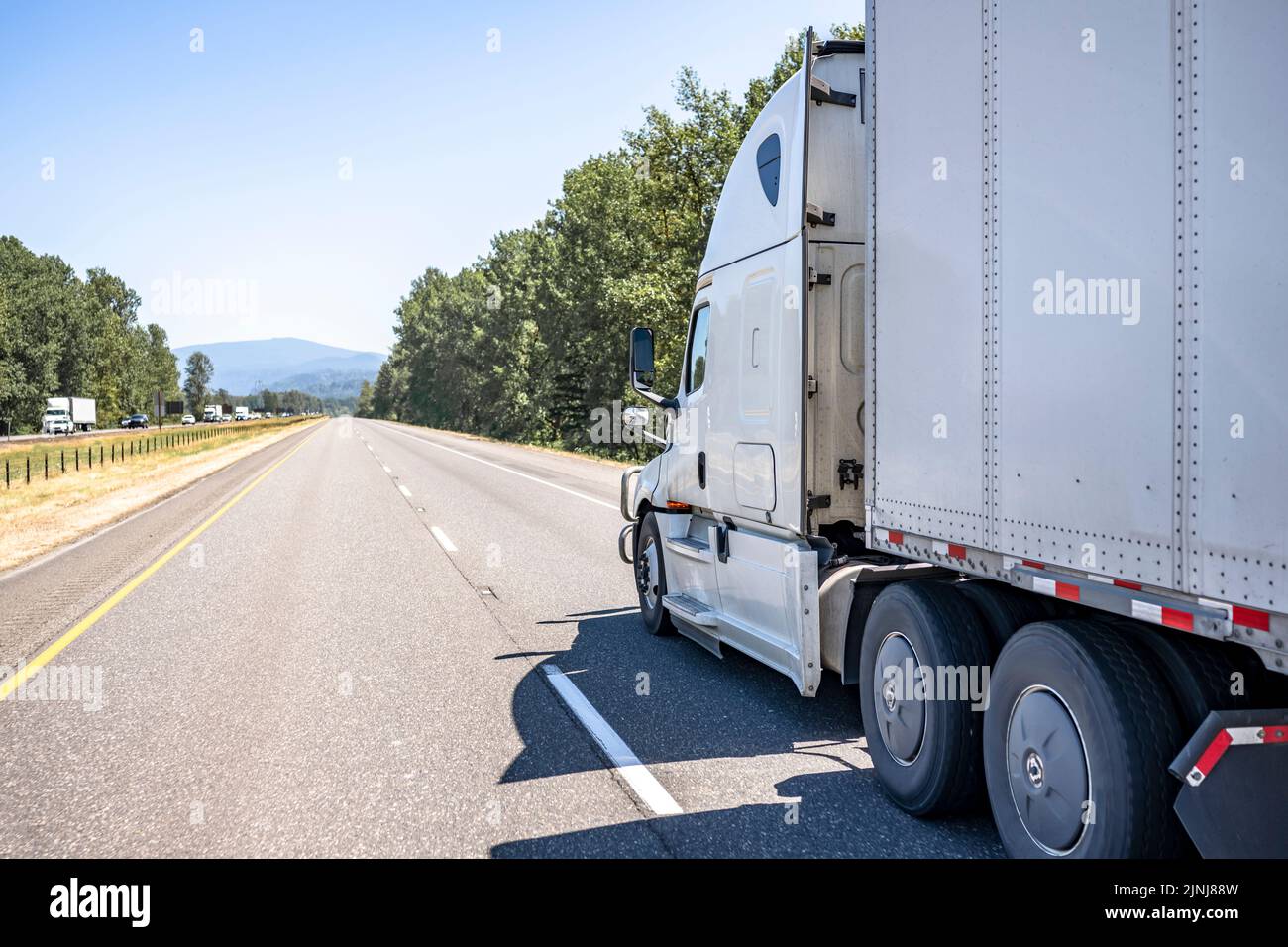 Industrial grade white big rig semi truck with high roof and sleeping ...