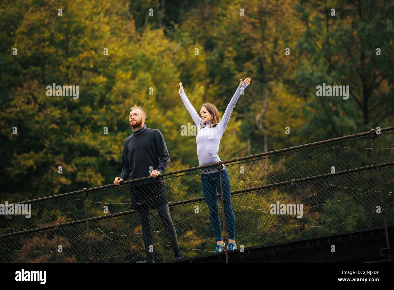 Mountain forest landscape. Young happy man and woman with joyful facial ...