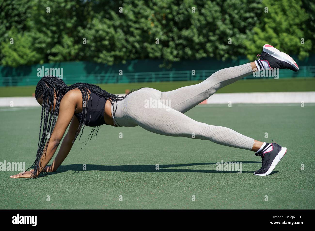 Woman beginner starts intensive training for all types of muscles to keep body fit on sports ...