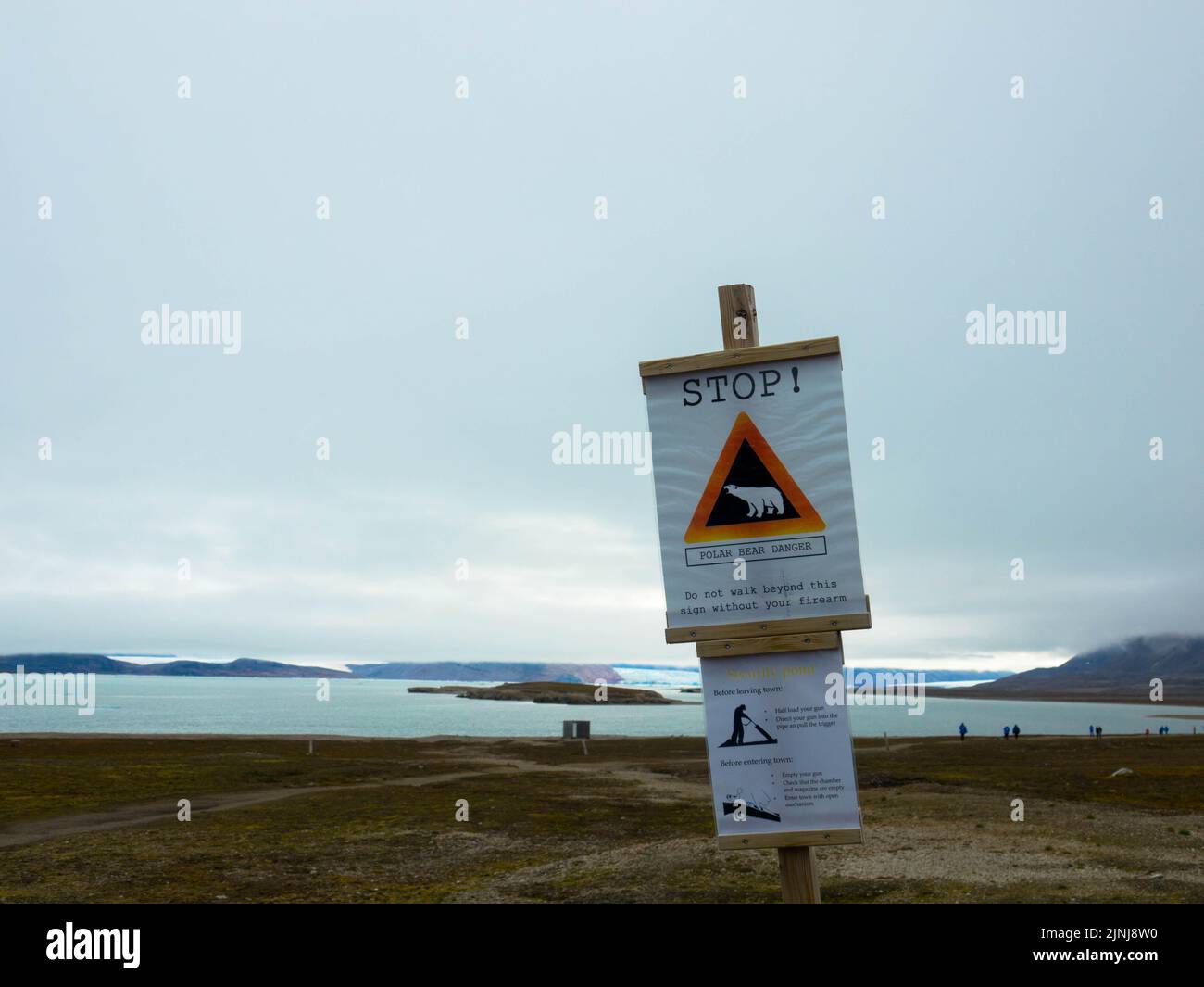 Attention, polar bear. Warning sign against gray sky. Seen in Ny ...