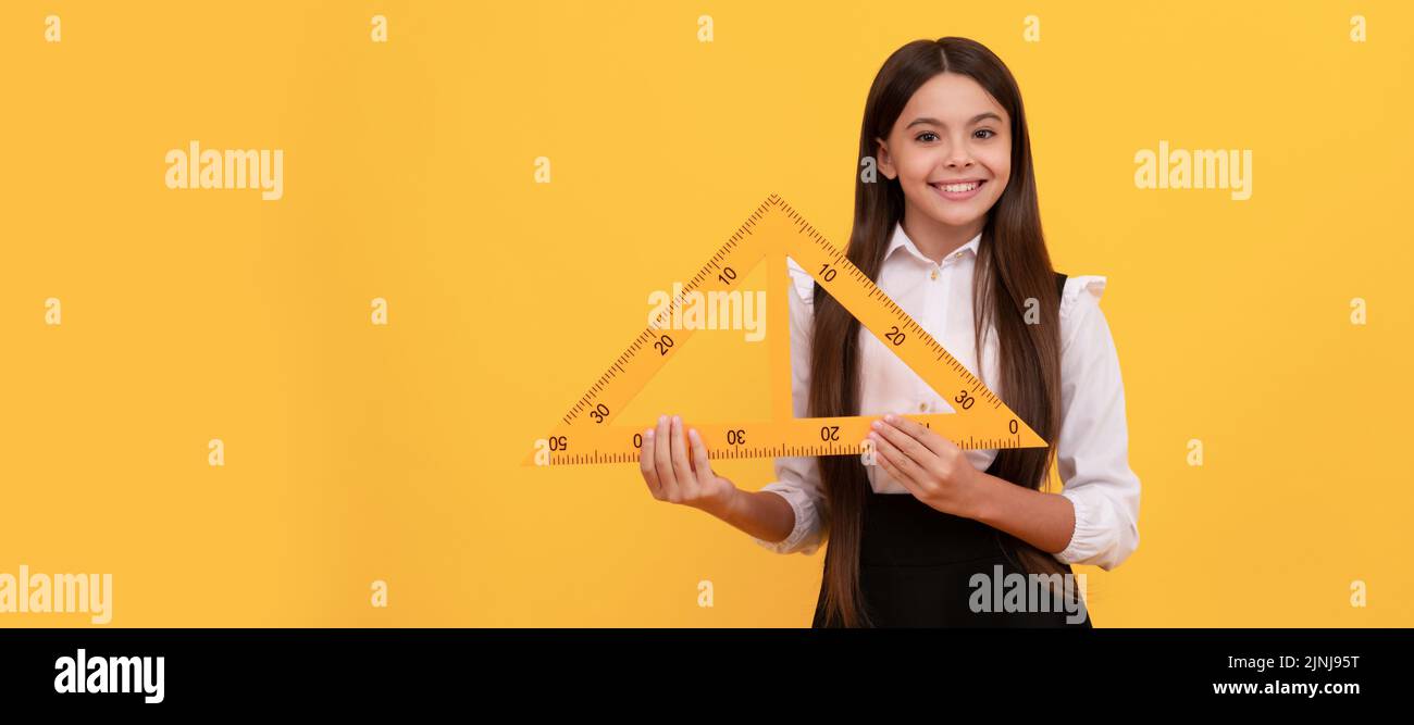 smiling kid in school uniform hold mathematics triangle for measuring ...