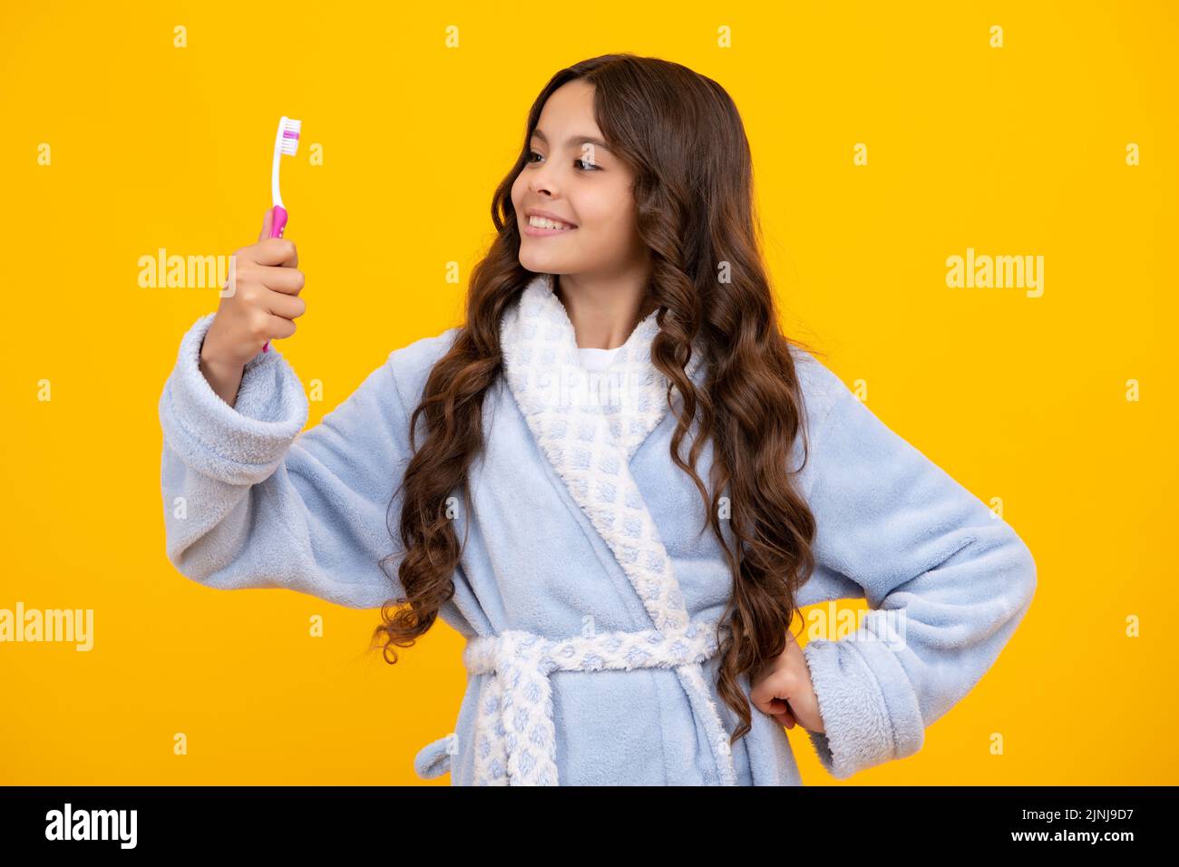 Night brushing teeth. Girl cleans her teeth with a brush. Portrait ...