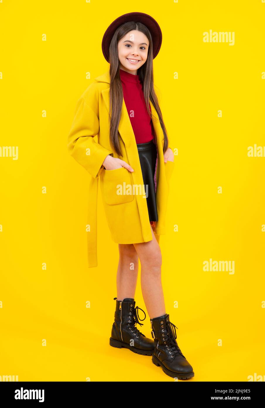 Elegant fashion teenager child girl in autumn coat posing in studio ...