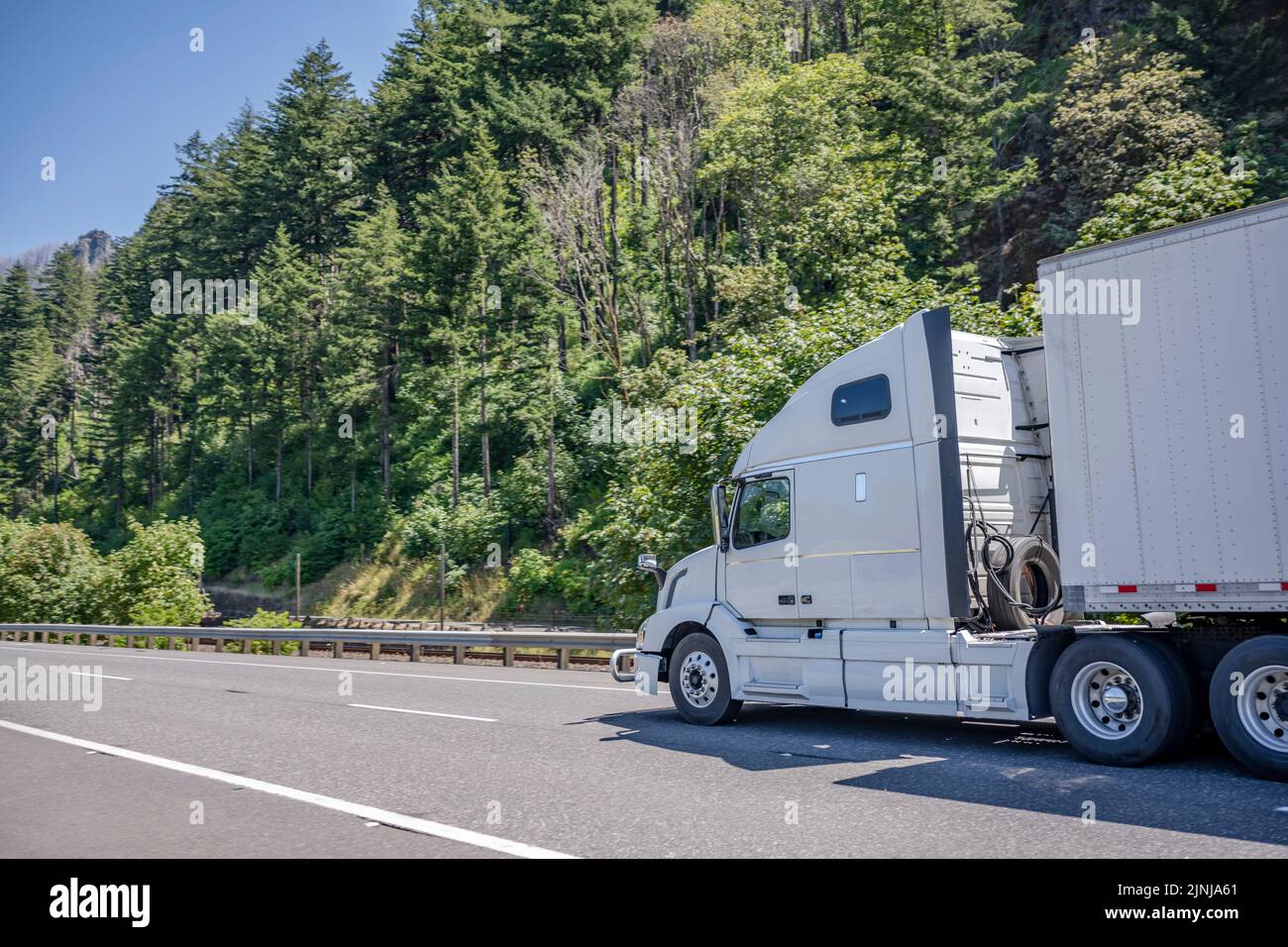 White industrial big rig semi truck with truck driver cab sleep ...