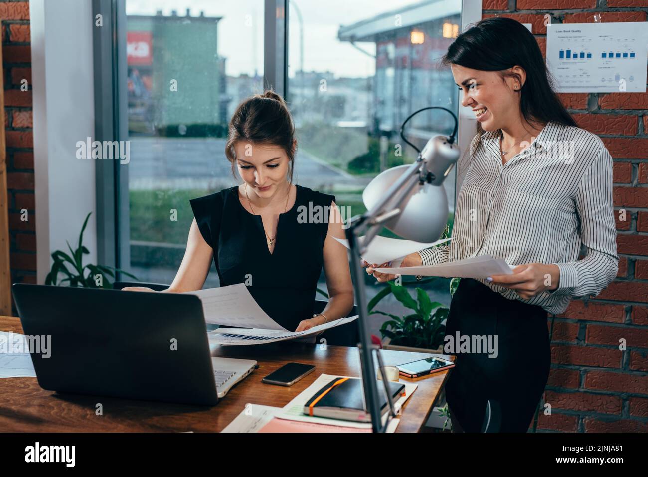 Young personal assistant discussing plans with boss in her office Stock ...