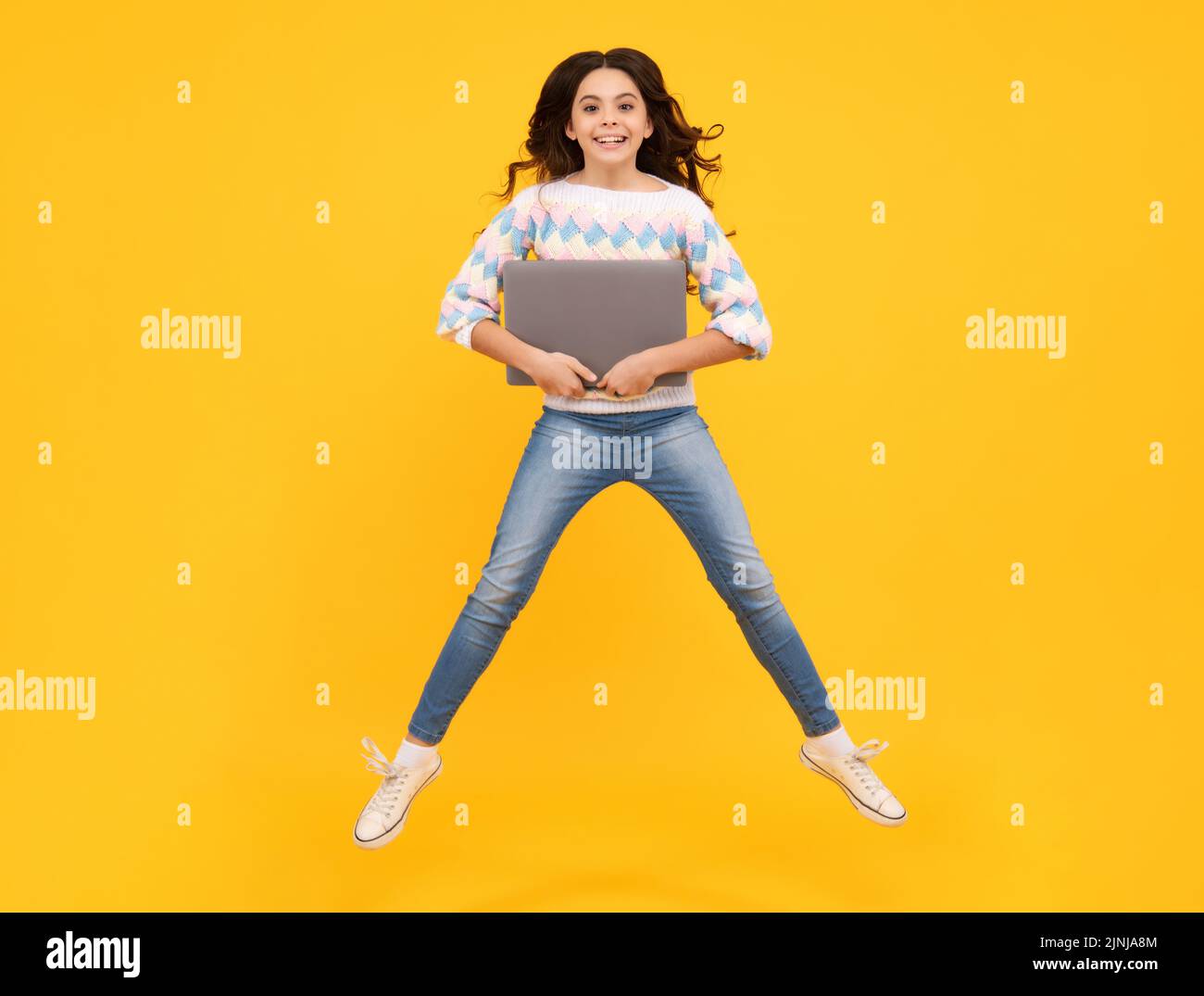 Young girl student hold computer. Funny pupil with laptop isolated on ...