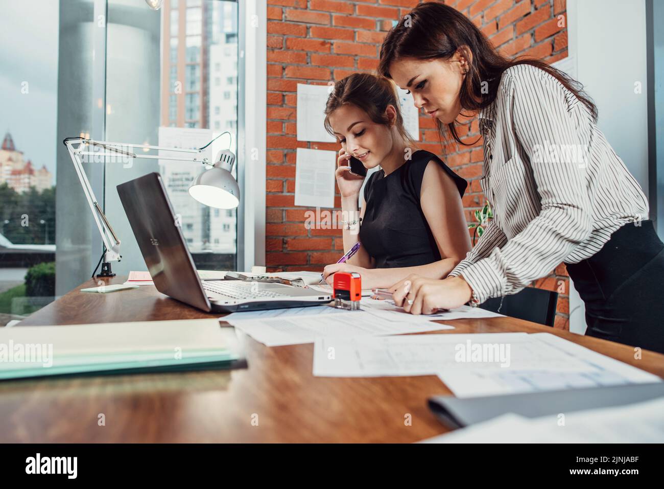 Two female colleagues in office working together Stock Photo - Alamy