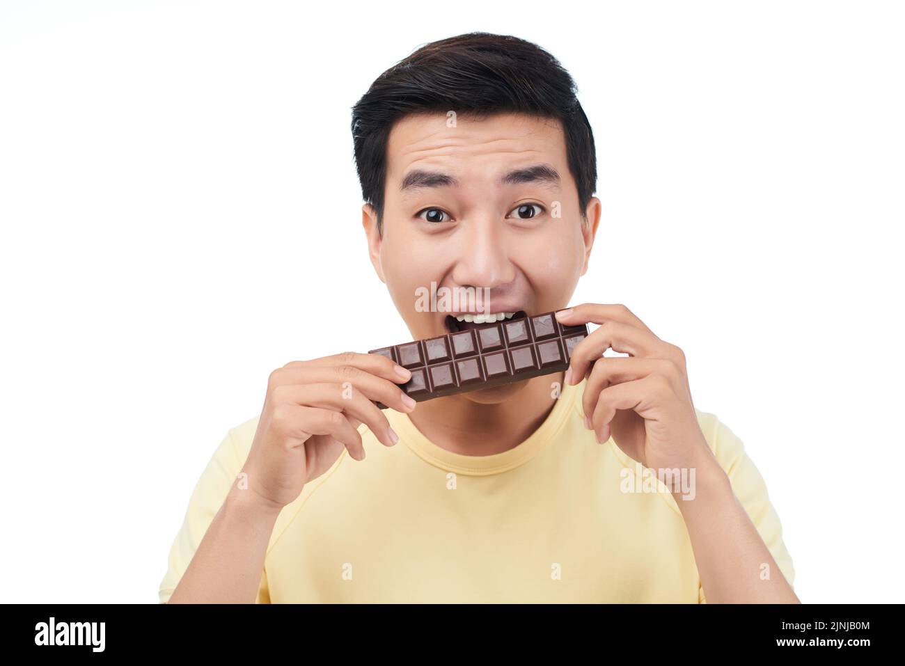 Man biting chocolate bar hi-res stock photography and images - Alamy