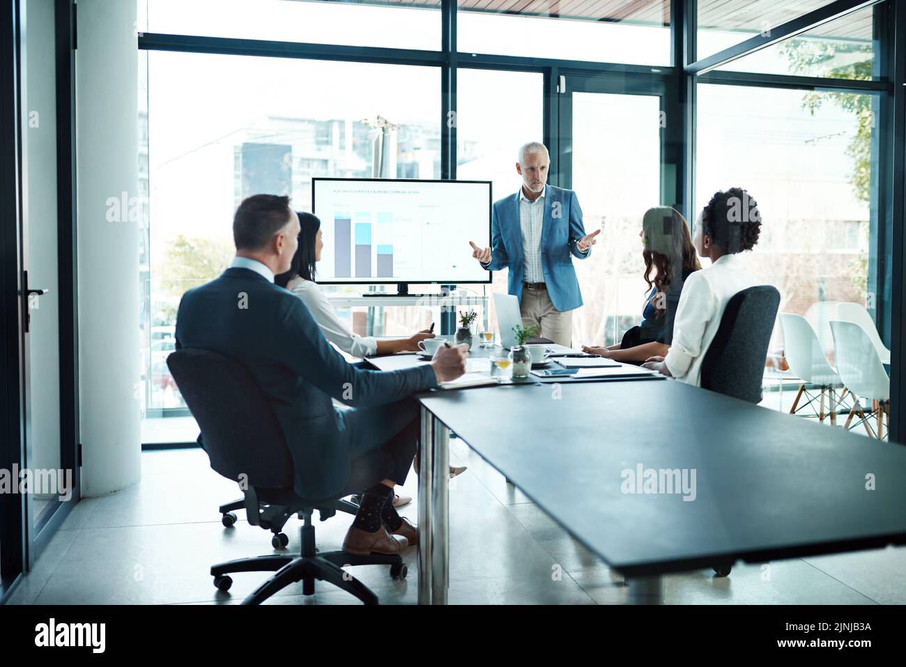 Manager, leader and boss talking to his team or group of colleagues in ...