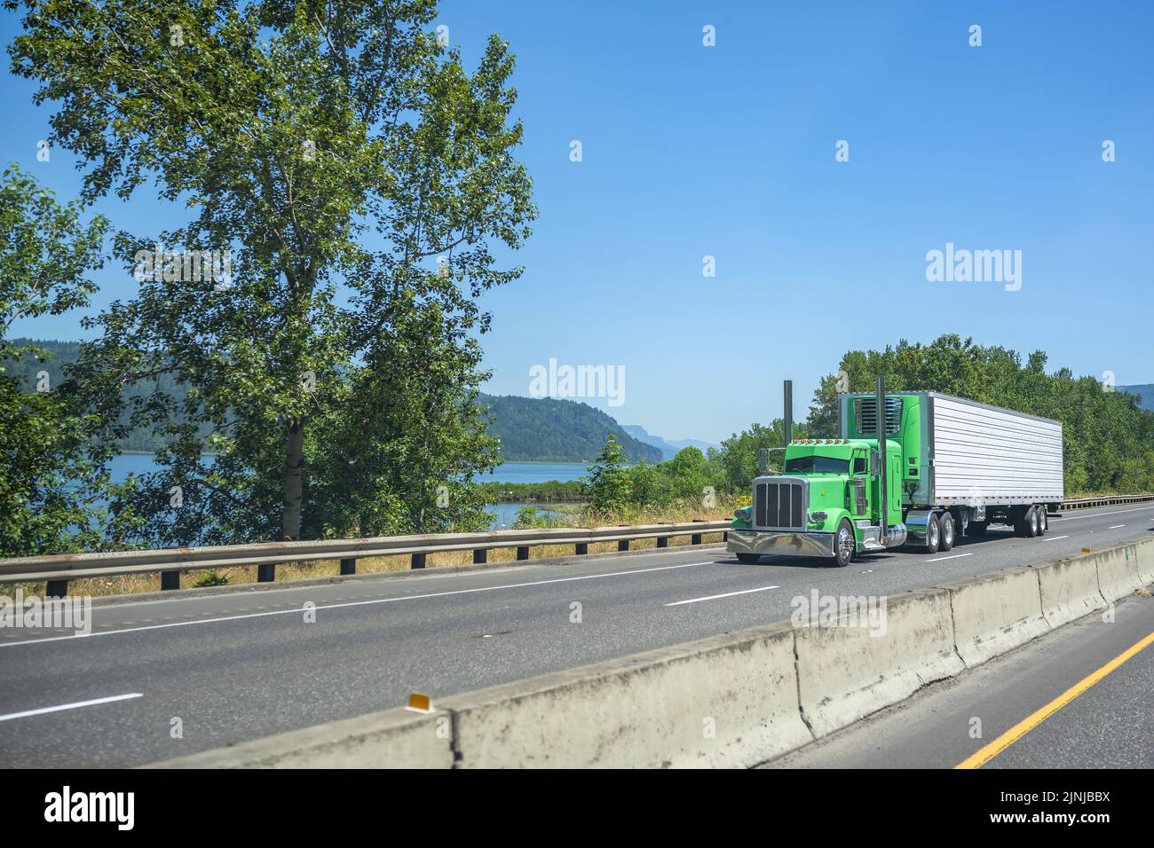 Bright green industrial big rig semi truck with high roof cab ...