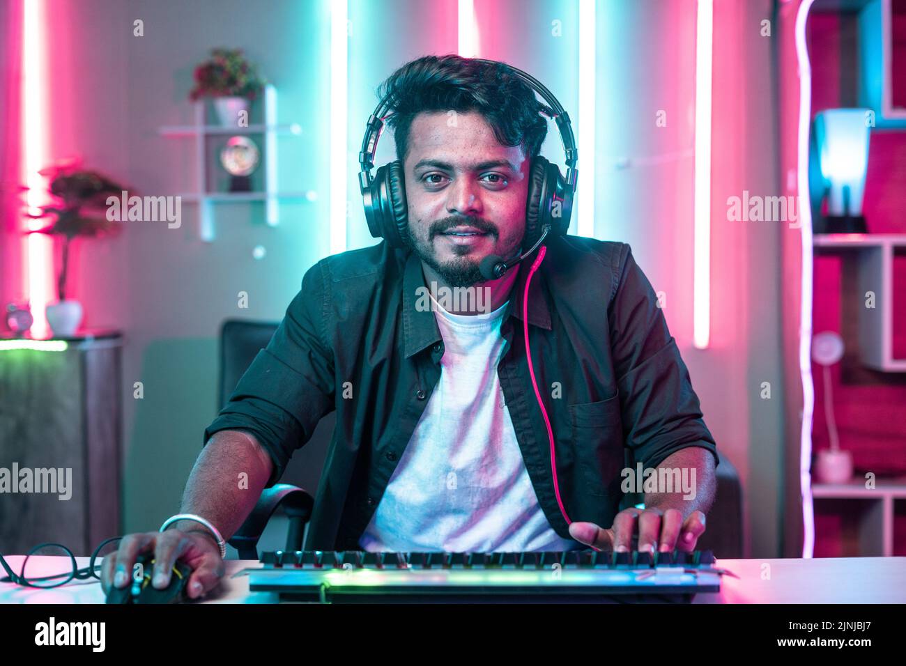 Excited gamer with headphones playing online video game by looking ...