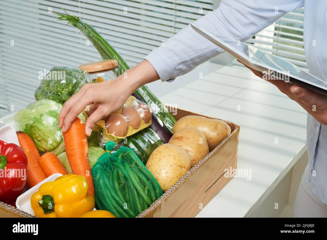 Hands of man checking fresh ogranic vegetables in the parcel her ...