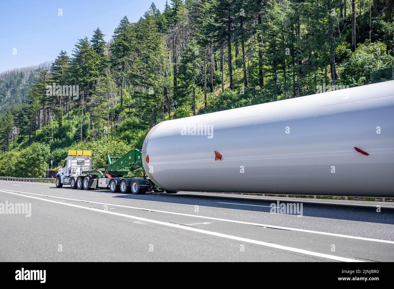 Heavy duty big rig semi truck transporting part of long oversized ...