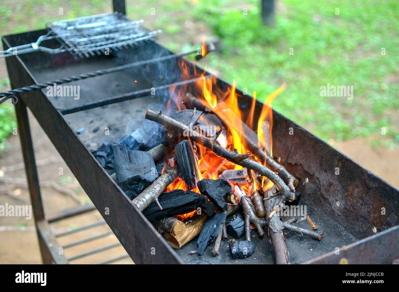 an empty brazier with a burning bonfire fire against the background of ...