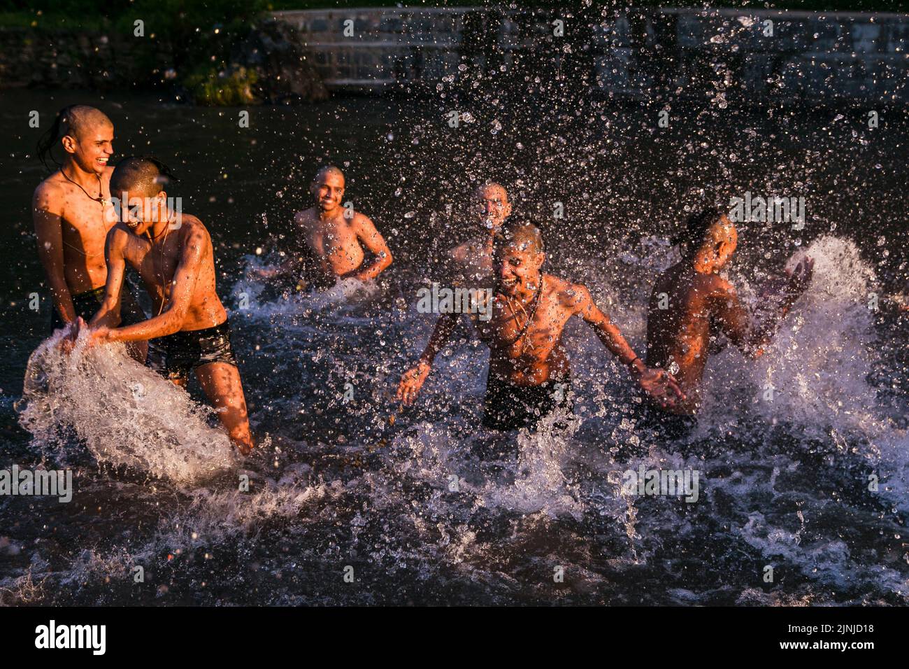 Kathmandu, Nepal. 12th Aug, 2022. Hindu priests take a holy bath as ...
