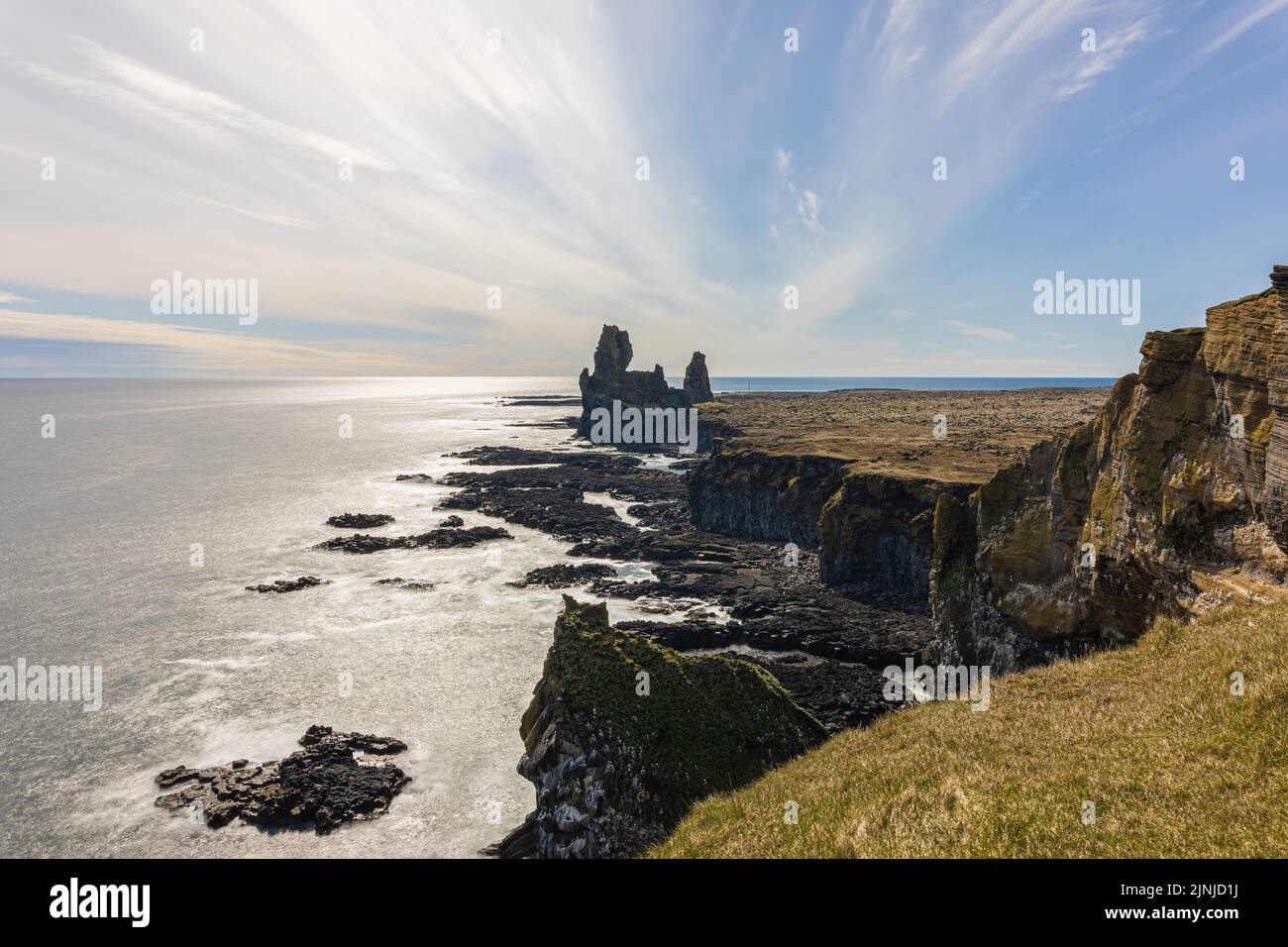 A long exposure shot of Arnarstapi cliff on the coastline of ...