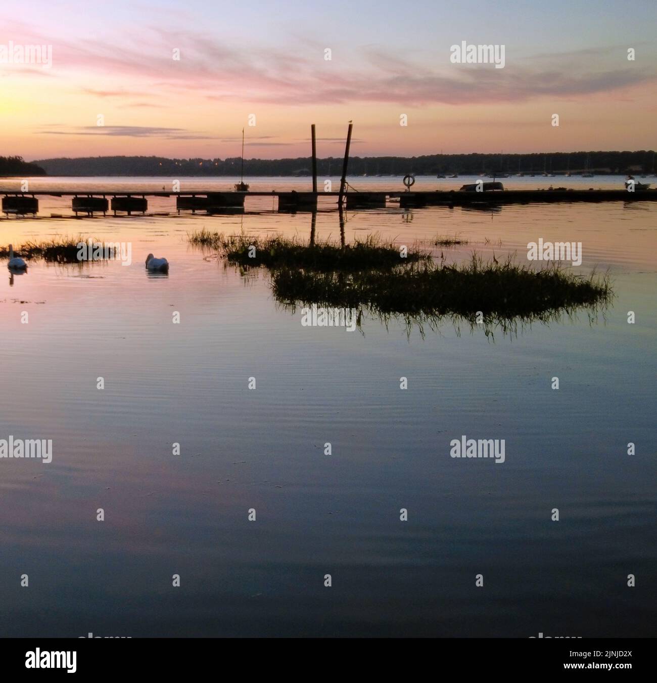 A mesmerizing view of a beautiful seascape at scenic sunset in Pin Mill ...