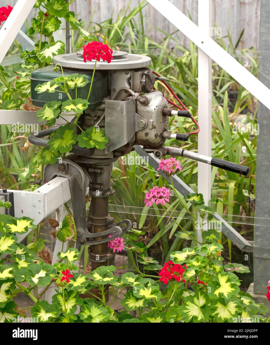 Old vintage outboard boat motor engine, covered in flowers Stock Photo ...