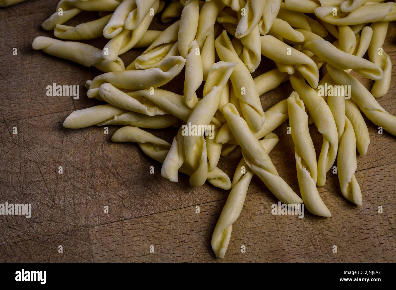 raw strozzapreti, specialties from northern Italy, fresh twisted pasta ...