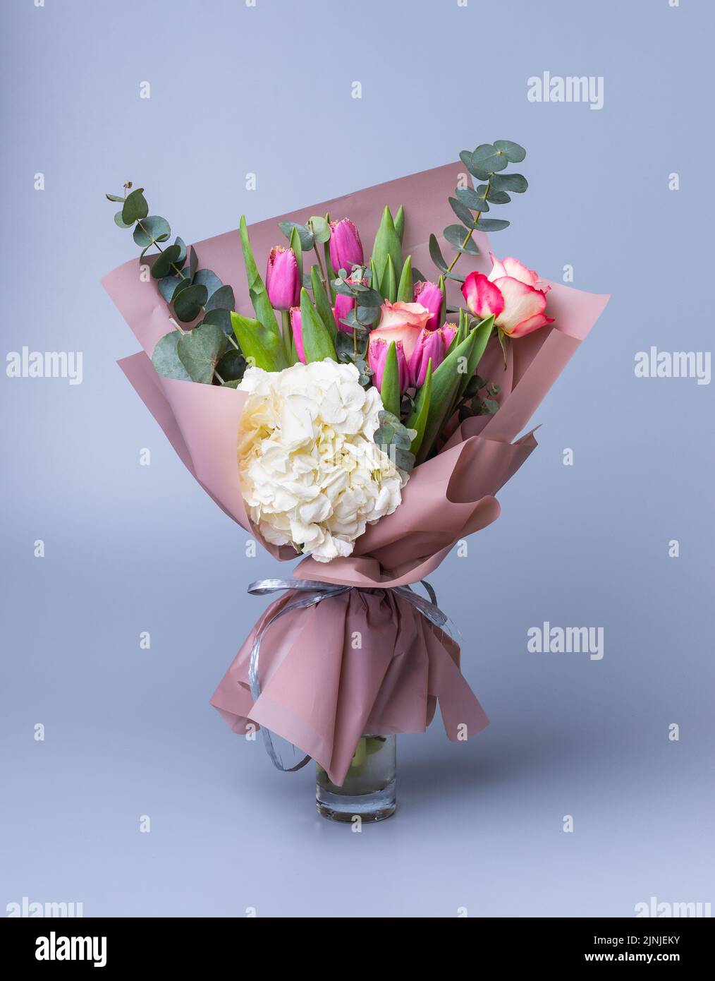 Handmade bouquet for Mother's Day in a festive paper package stands in ...