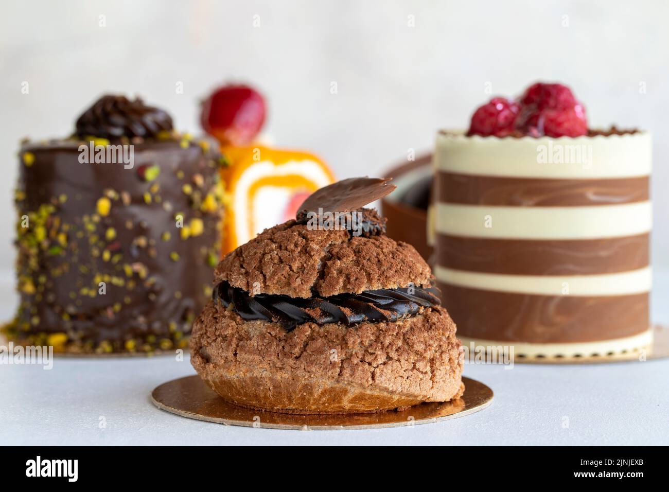 Types of cakes. Small sweet cakes on a white background. Bakery ...