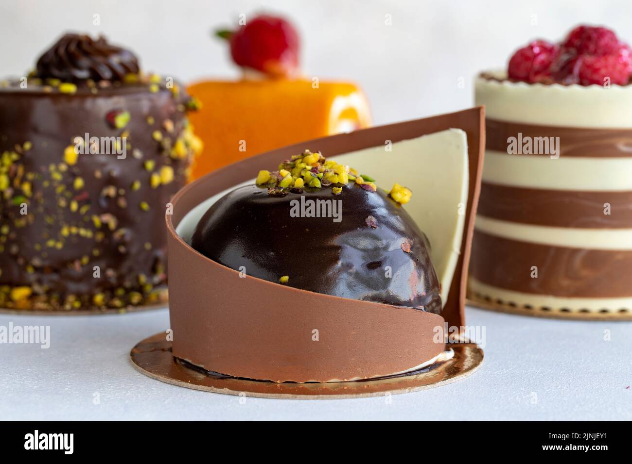 Types of cakes. Small sweet cakes on a white background. Bakery ...