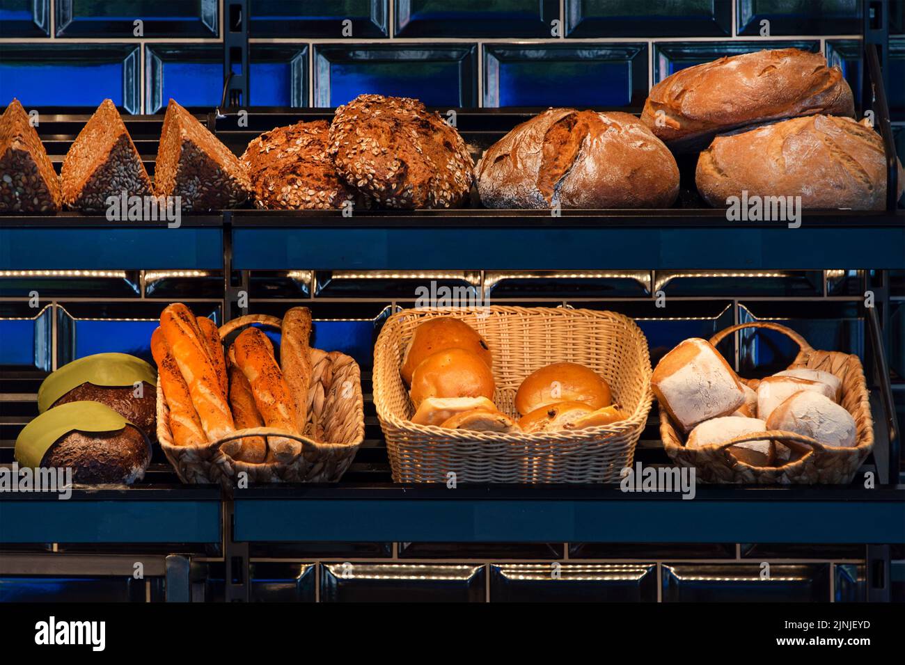 Freshly baked bread on a shelves in bakery, baguette and rolls ...