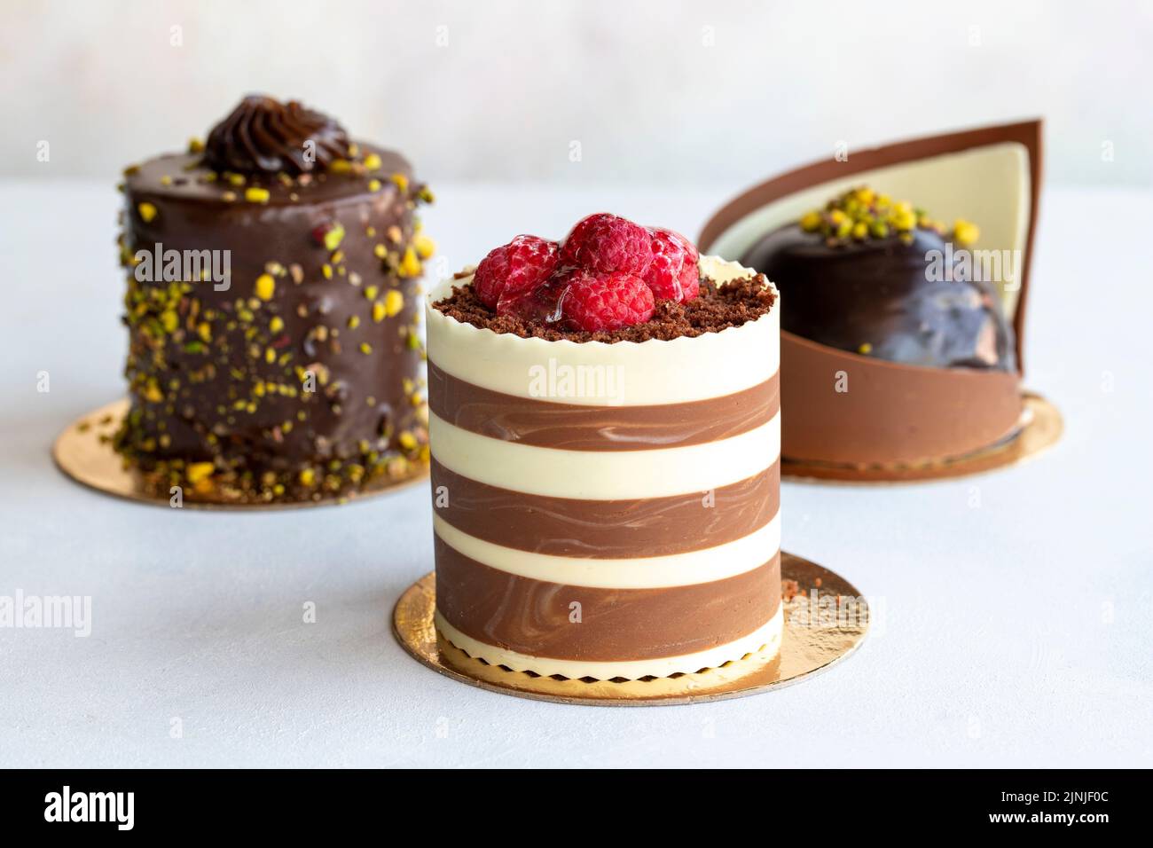 Types of cakes. Small sweet cakes on a white background. Bakery ...