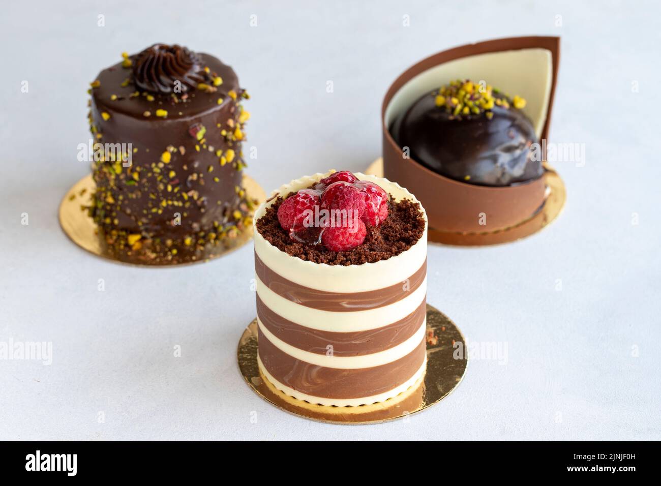 Types of cakes. Small sweet cakes on a white background. Bakery ...