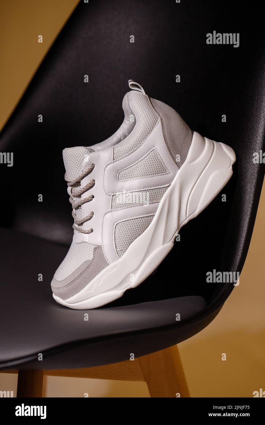 Showing details on sneakers. Close up of one white sneaker standing ...