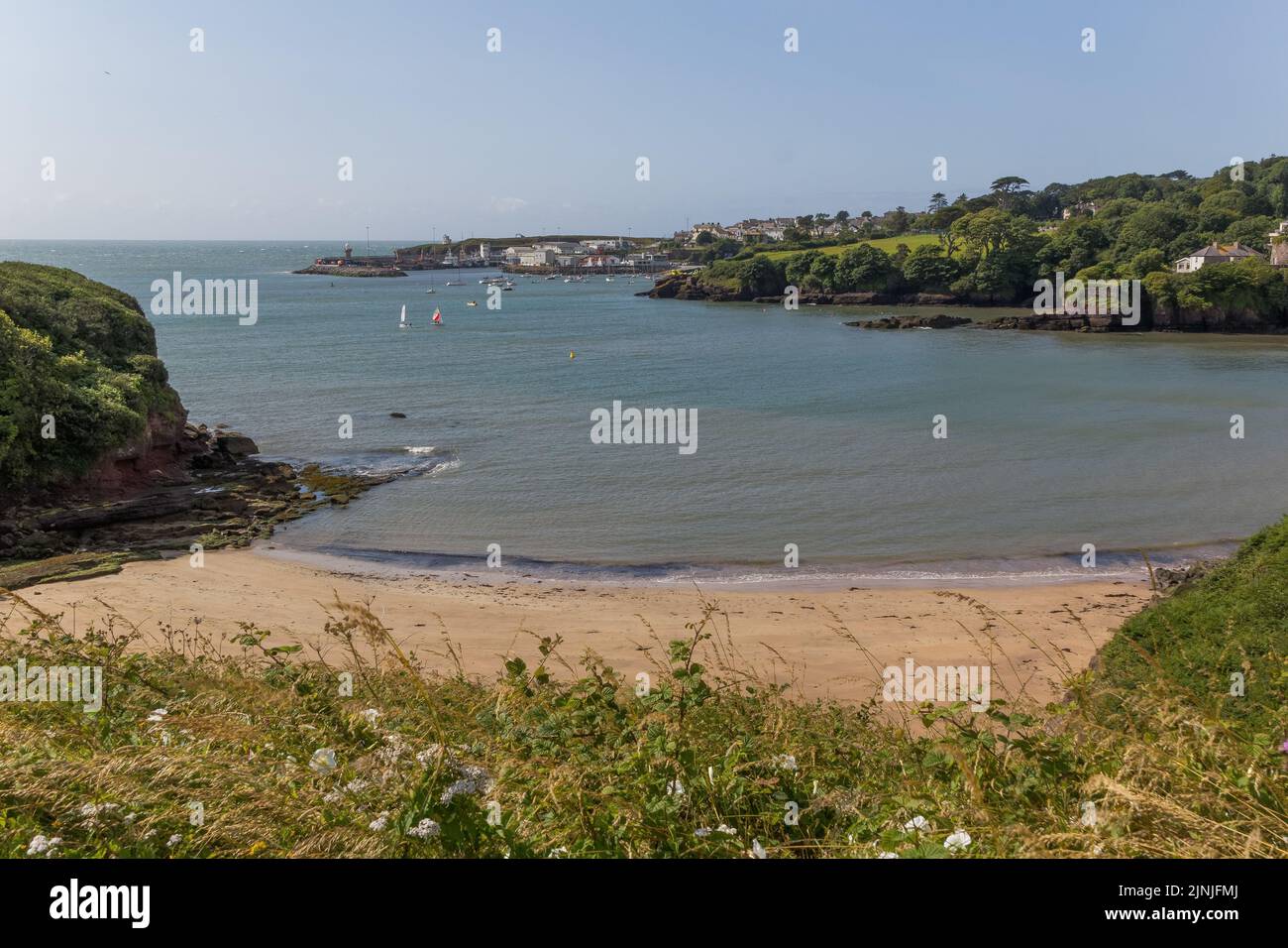 A beautiful seascape of green hills and blue water in Ireland on a ...