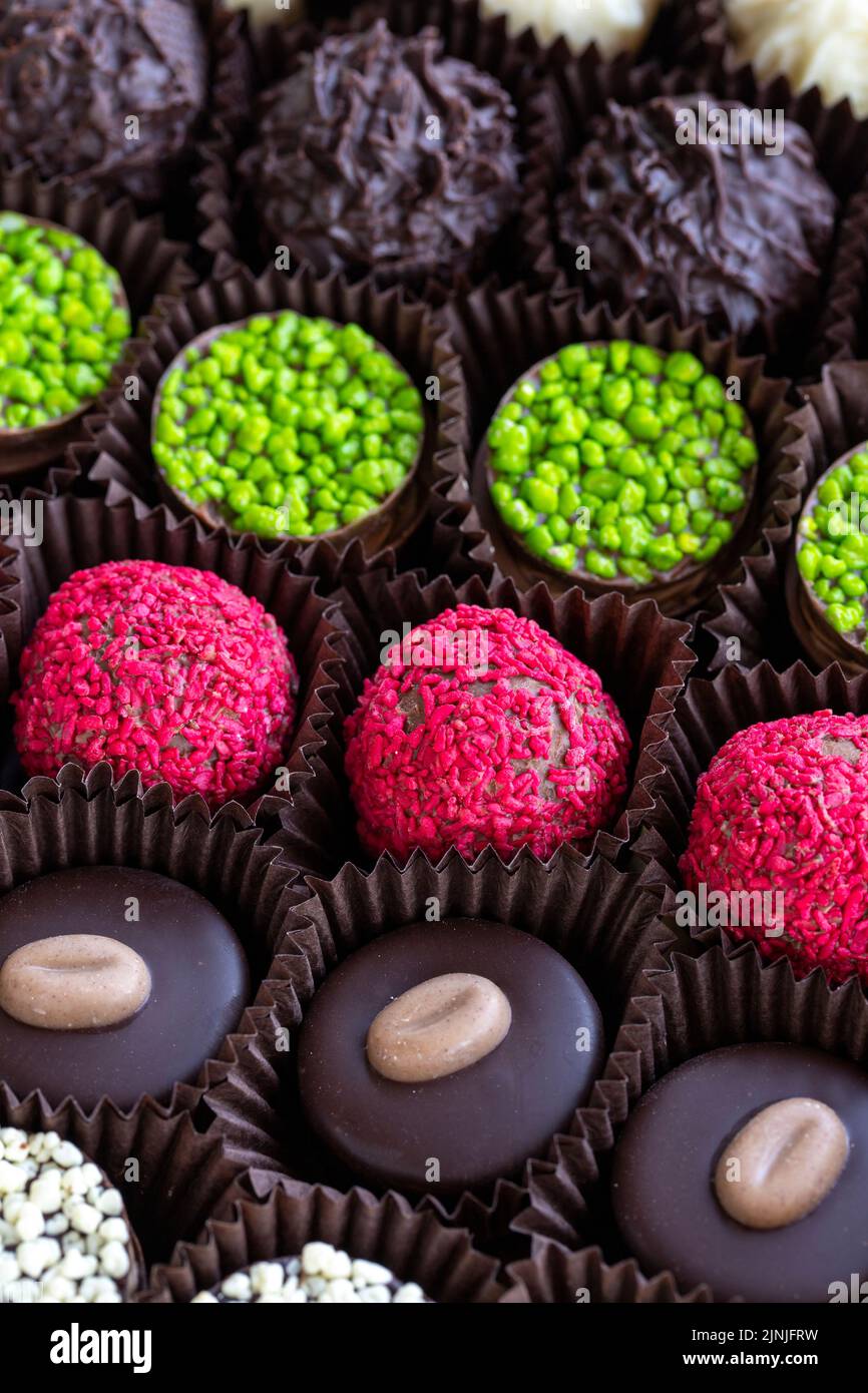 Packed chocolate. Assortment of packed truffle chocolates on a white ...