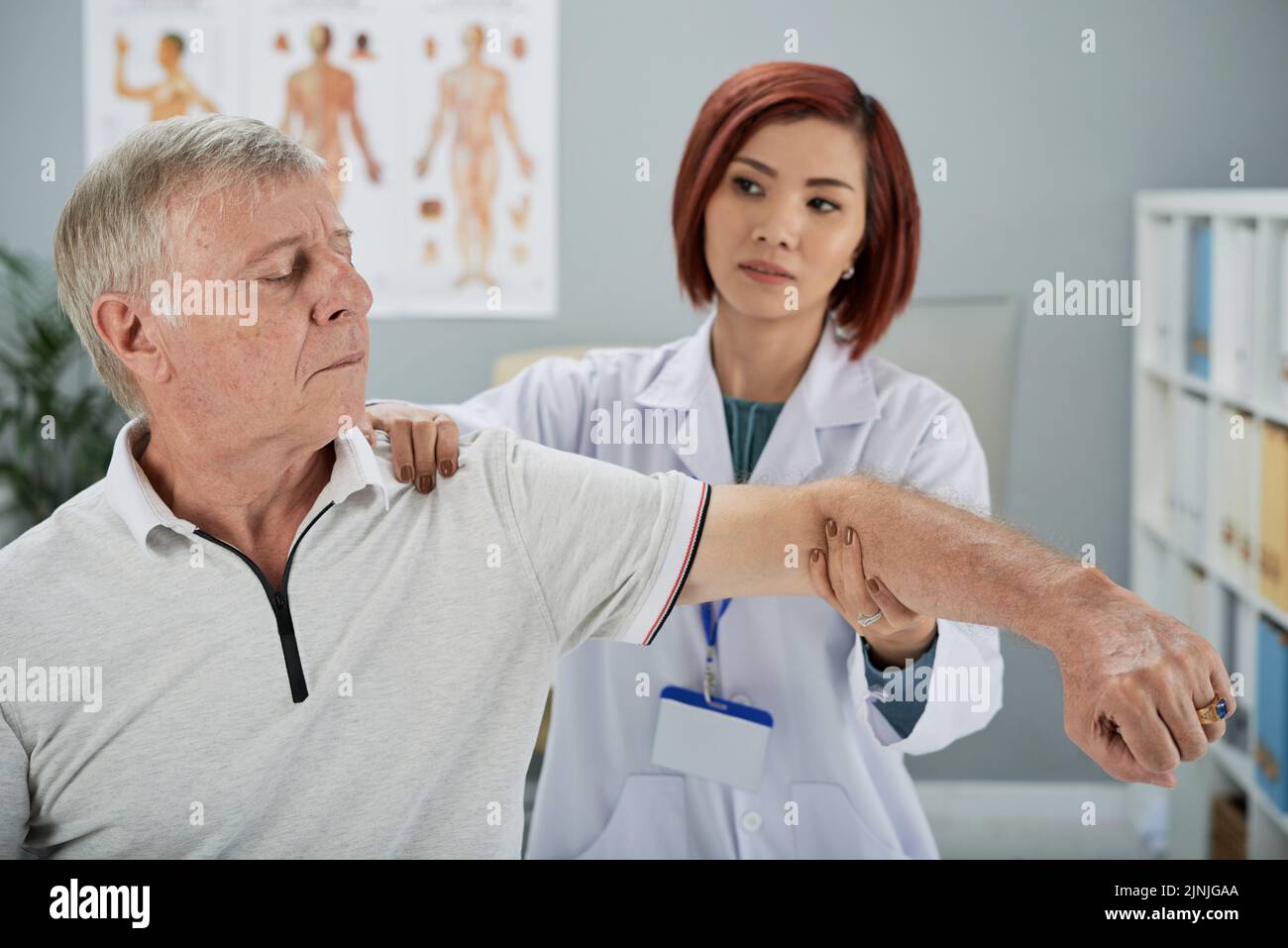 Young female rehabilitation center worker working with patient Stock ...