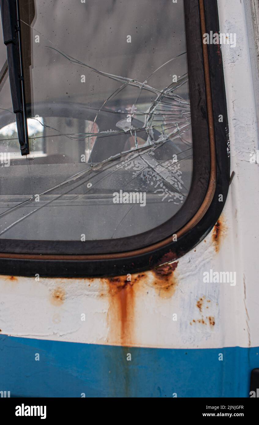A vertical closeup of an old bus with a broken windshield Stock Photo ...