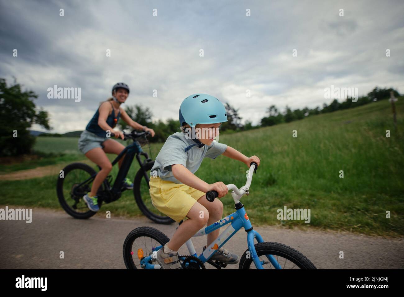 Child riding bicycle side view helmet hi-res stock photography and ...