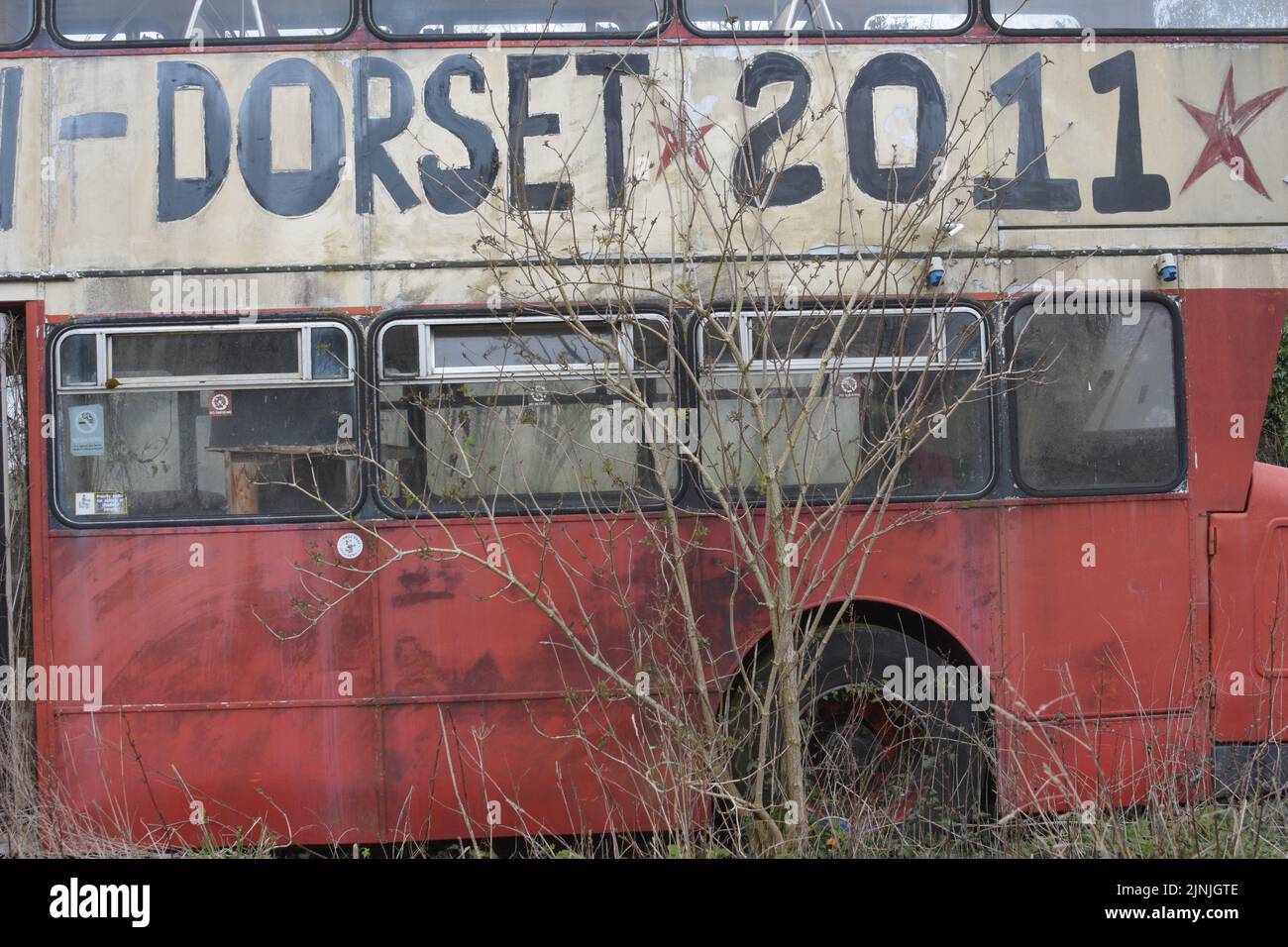 Dorset 2011 red double-decker bus abandoned on a farm on Dorset UK ...