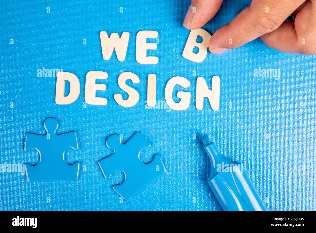 Web Design. Text from white wooden letters on a blue background Stock ...