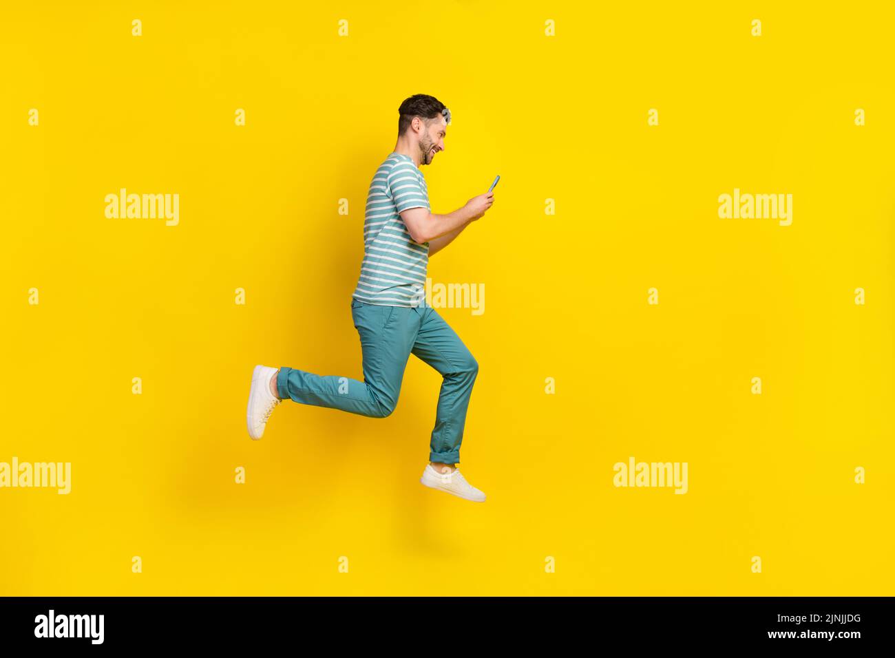 Full length photo of funny guy run type telephone wear t-shirt jeans ...