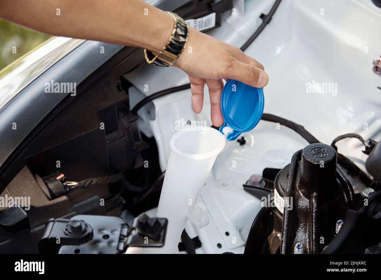 Car owner checking level of windshield washer fluid Stock Photo - Alamy