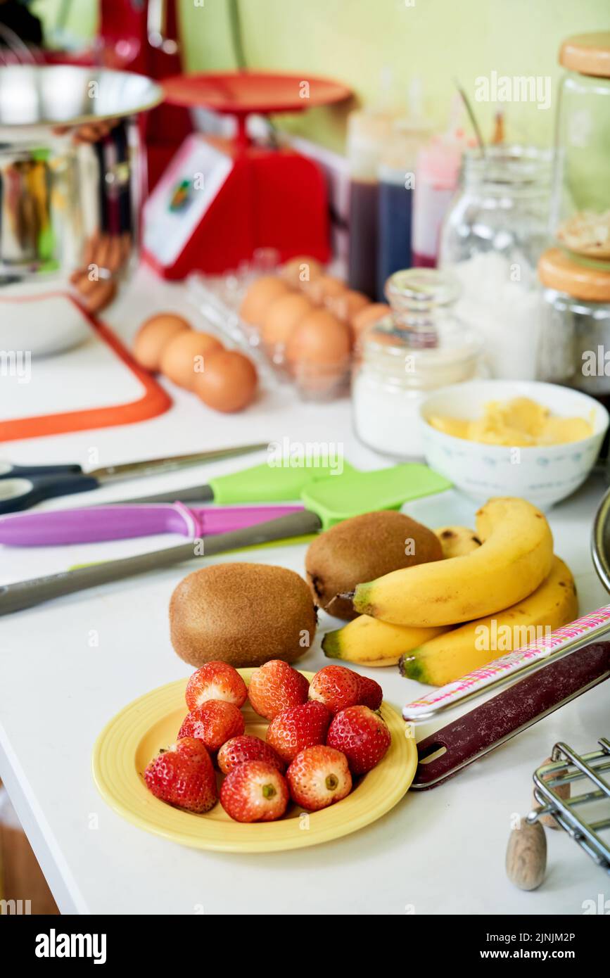 Fresh fruits and tools on kitchen table Stock Photo - Alamy