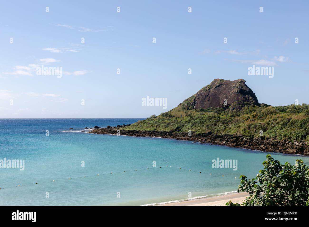 An aerial view of Xiaowan Little Bay beach in background of greenery ...