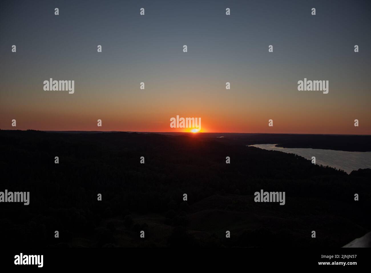 Sunset in Denmark. Warm colors. Sun setting down on the horizon and sun ...